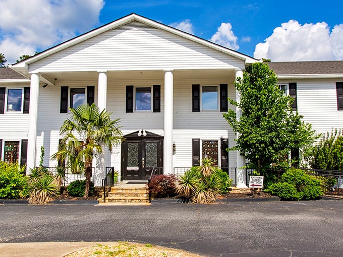 Southern charm meets textile heaven in this stately white mansion. Who knew fabric shopping could come with columns and palm trees?