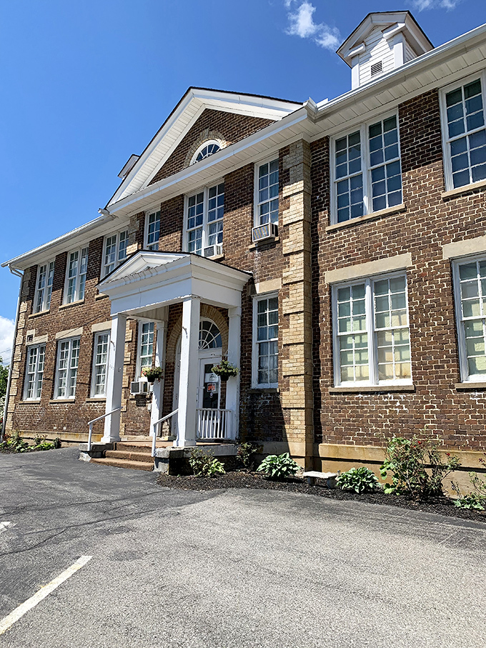 The stately brick exterior of Schoolhouse Fabrics stands as a testament to its educational past, now housing three floors of textile treasures.