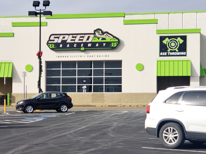 The vibrant green exterior beckons speed enthusiasts like a neon sign in the desert. Racing paradise awaits behind those unassuming walls.