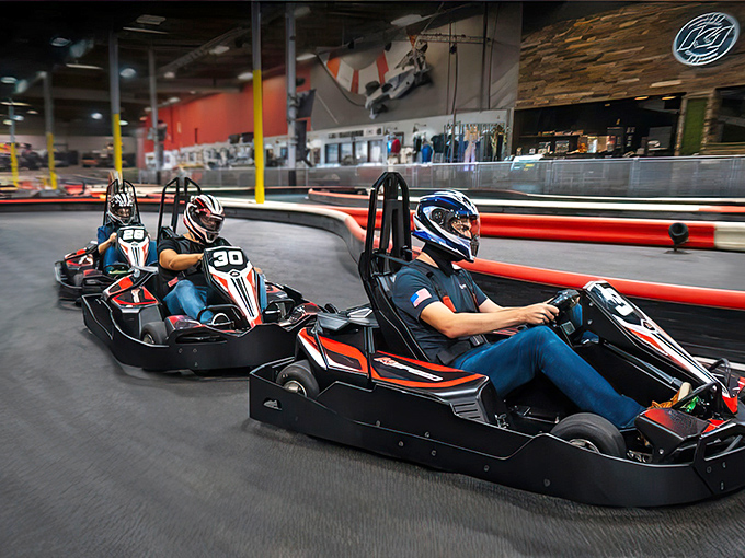 The checkered flag awaits as electric karts zoom around K1 Speed's professionally designed indoor track. Racing dreams come true regardless of weather outside.