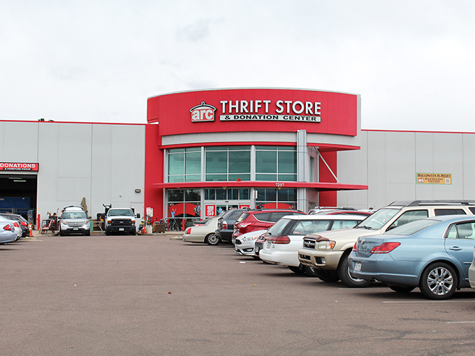 The bold red entrance of Arc Thrift Store beckons like a retail lighthouse, promising treasure hunters the thrill of discovery within its cavernous interior.