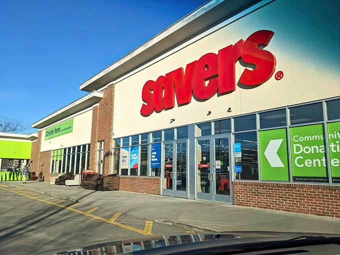 The iconic red Savers sign beckons like a lighthouse for bargain hunters, promising treasures waiting just beyond those sliding glass doors.