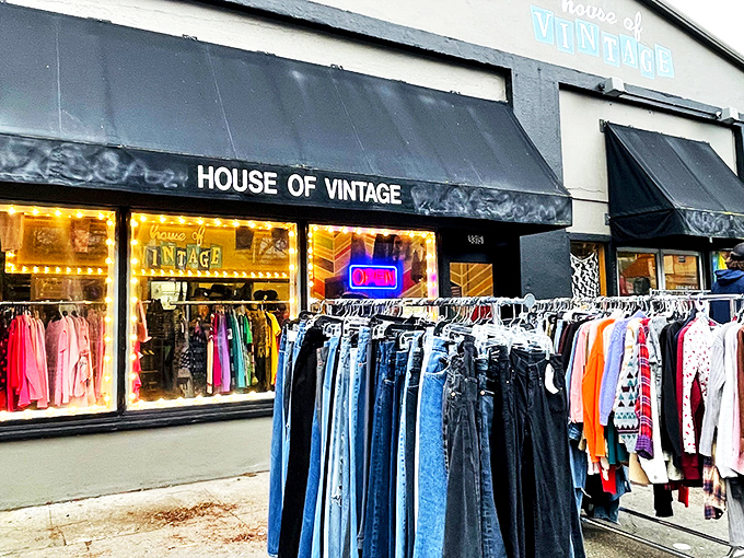 The unassuming storefront of House of Vintage beckons with colorful clothing racks outside, like a portal to decades past waiting to be explored. 