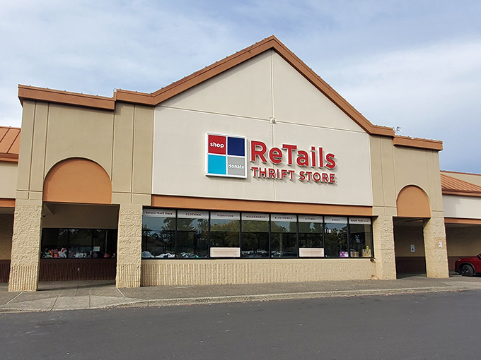 A rainbow arches over ReTails like nature's own "Open" sign, promising treasure hunters a pot of second-hand gold within those beige walls.