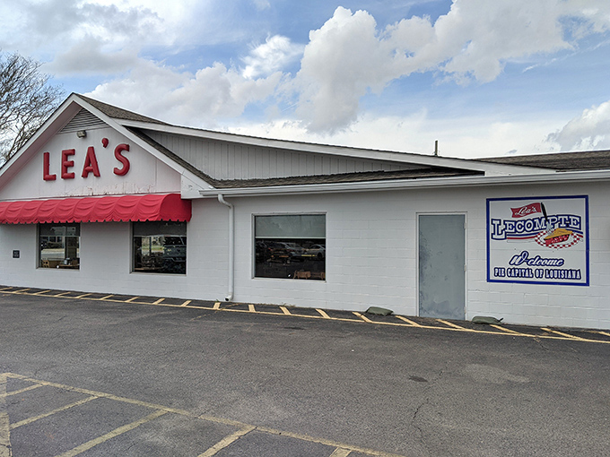 Lea's iconic white exterior with its cherry-red awning stands as a beacon of hope for hungry travelers. Simple, unassuming, and promising delicious rewards inside. 