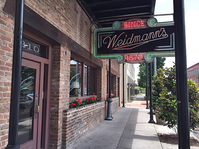 The iconic neon sign of Weidmann's glows like a beacon of culinary hope on a downtown Meridian street. Southern hospitality awaits just beyond those doors.