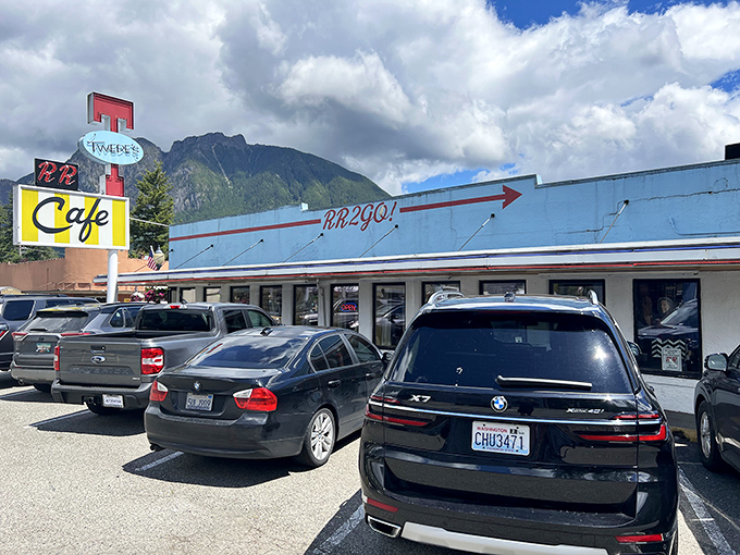 The iconic blue and yellow Twede's Cafe sign stands tall against the Washington sky, beckoning hungry travelers with promises of pie-fueled happiness.