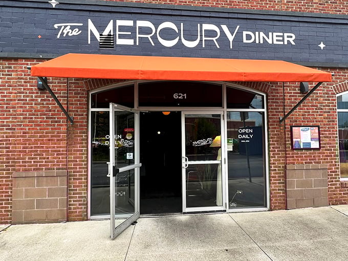 The Mercury Diner's navy blue facade with bright orange awning isn't just inviting&mdash;it's practically a bat signal for hungry Ohioans seeking comfort food nirvana. 