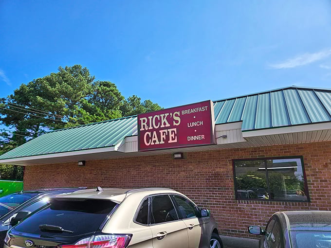 The unassuming brick exterior of Rick's Cafe stands like a culinary lighthouse, its green roof and straightforward signage promising honest food without pretense.