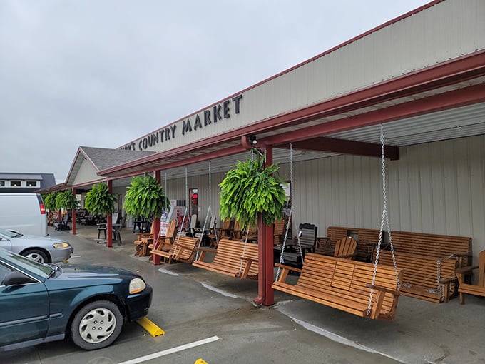 Wooden porch swings beckon hungry travelers outside Shirk's Country Market, where rural charm meets sandwich excellence in Centertown, Missouri.