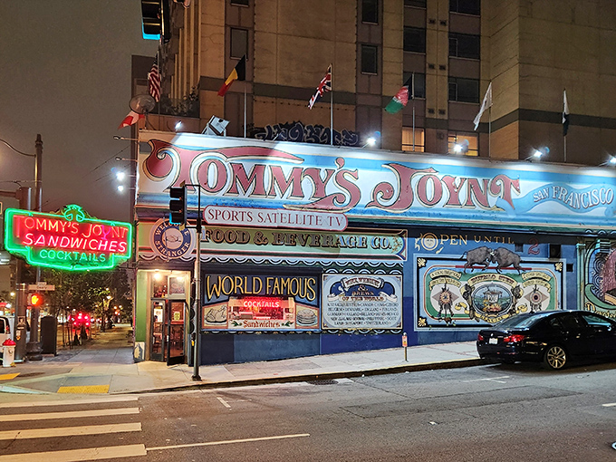 The unmistakable blue exterior of Tommy's Joynt stands like a colorful time capsule on Van Ness Avenue, complete with international flags and hand-painted promises of culinary delights within.
