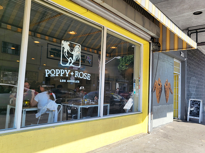 The sunshine-yellow exterior of Poppy + Rose beckons like a culinary lighthouse amid downtown LA's Flower District, promising comfort food worth the journey.