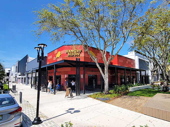 The distinctive red facade of The Hangry Bison stands out in Winter Park like a beacon for burger enthusiasts seeking meaty salvation.