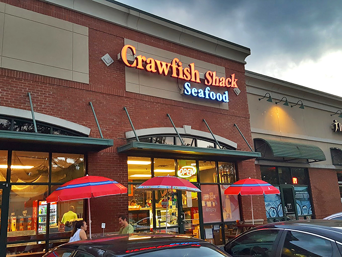 The red neon sign beckons like a lighthouse for seafood lovers. Strip mall location, zero pretension&mdash;just the promise of oceanic treasures within.