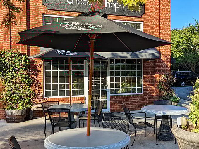 The unassuming brick exterior of Chops & Hops promises no gimmicks—just serious food. Those black umbrellas aren't sheltering celebrities, just lucky diners about to have their taste buds transformed.