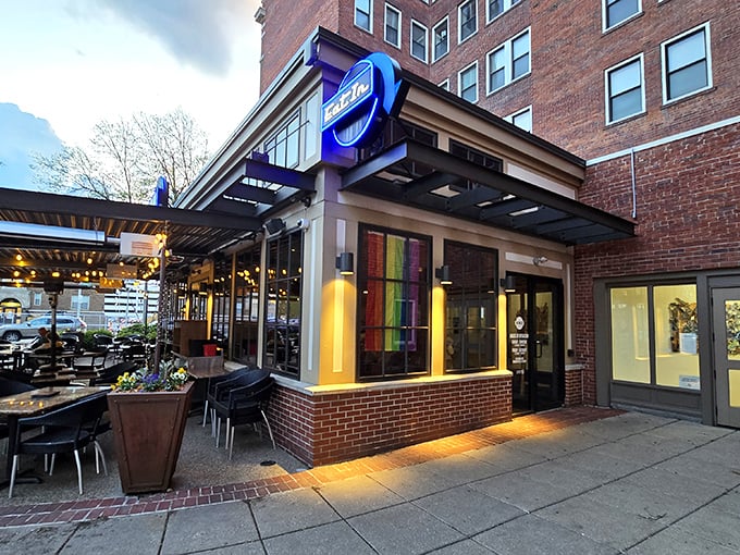 The iconic blue BRU sign beckons hungry patrons like a burger lighthouse on Mass Ave's brick-lined shores. Come for the burgers, stay for the patio vibes.