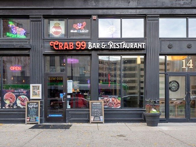 The neon glow of Crab 99's sign cuts through the night like a lighthouse for seafood-starved Midwesterners, promising oceanic treasures in downtown Indy.