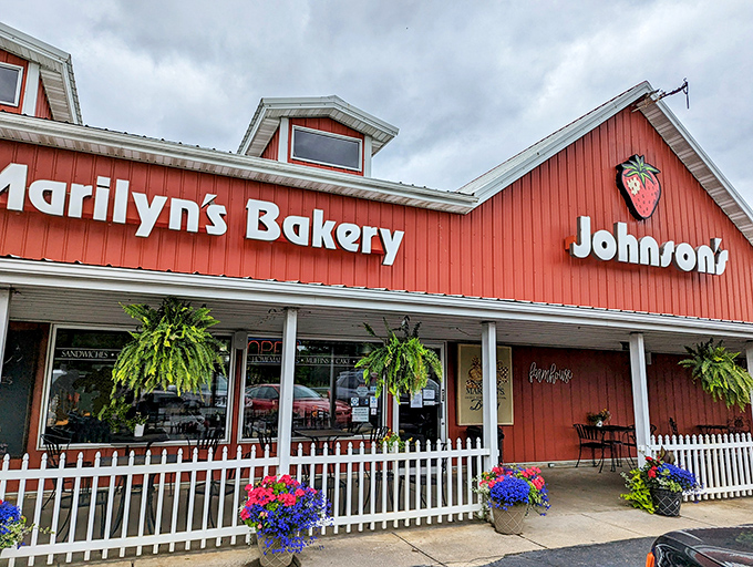 The iconic red building with its white picket fence and hanging ferns makes promises that the bakers inside absolutely keep.