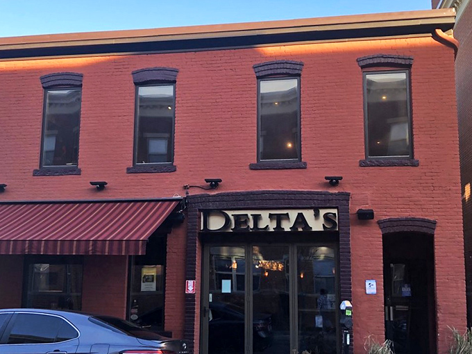 Delta's distinctive brick facade glows with promise at dusk, like a Southern lighthouse beckoning hungry travelers to safe harbor.