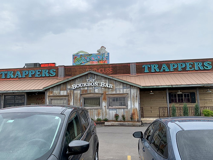 The weathered wooden exterior of Trapper's Bourbon Bar isn't trying to impress anyone—which is exactly why it's so impressive.