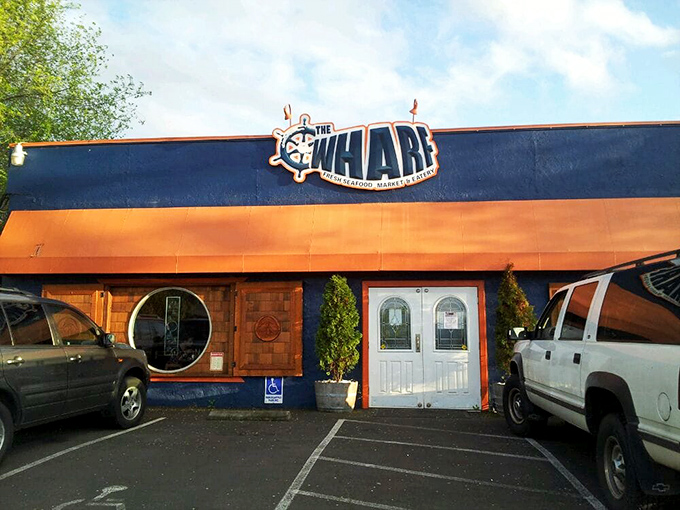 The bright blue exterior of The Wharf stands out like a maritime oasis in landlocked Medford, promising seafood treasures within those wooden-framed windows.