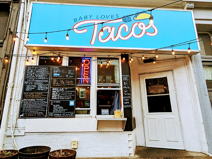 The bright blue sign promises taco salvation while the string lights invite you in like an old friend who happens to make incredible food.