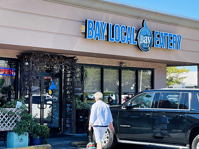 The coastal charm starts before you even step inside. Bay Local's entrance, adorned with lush greenery and rustic touches, promises a feast beyond the ordinary.