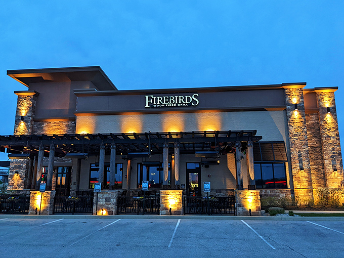 Modern meets rustic at Firebirds' exterior, where stone pillars and contemporary architecture promise a dining experience beyond the ordinary.
