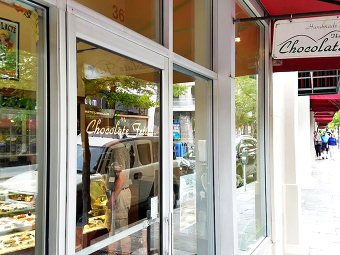 The storefront beckons like a chocolate siren, with award certificates proudly displayed. Resistance is futile—just look at that "OPEN" sign glowing with promise.