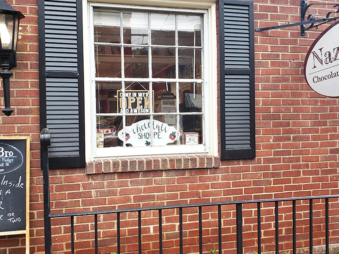 The unassuming brick storefront of NazBro Chocolates beckons with a promise that's impossible to resist: FREE FUDGE SAMPLES. Resistance is futile.