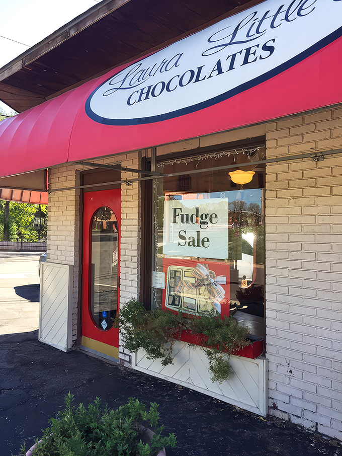 The iconic red awning of Laura Little's Candy Kitchen beckons like a sweet siren call, promising sugary treasures within this Prairie Village landmark.
