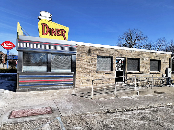 The classic stainless steel and stone exterior of The Oasis Diner stands like a time capsule on Plainfield's landscape, its iconic yellow sign beckoning hungry travelers.