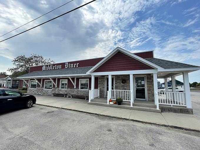 The classic red exterior of Middleton Diner stands like a beacon of comfort food promise against Michigan's ever-changing skies.