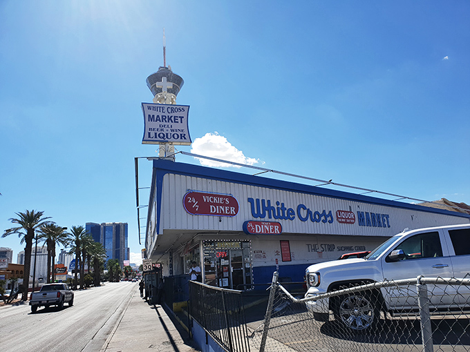 The unmistakable red-and-white exterior of Vickie's Diner stands like a time capsule amid the desert landscape, promising comfort food salvation to weary Vegas travelers.