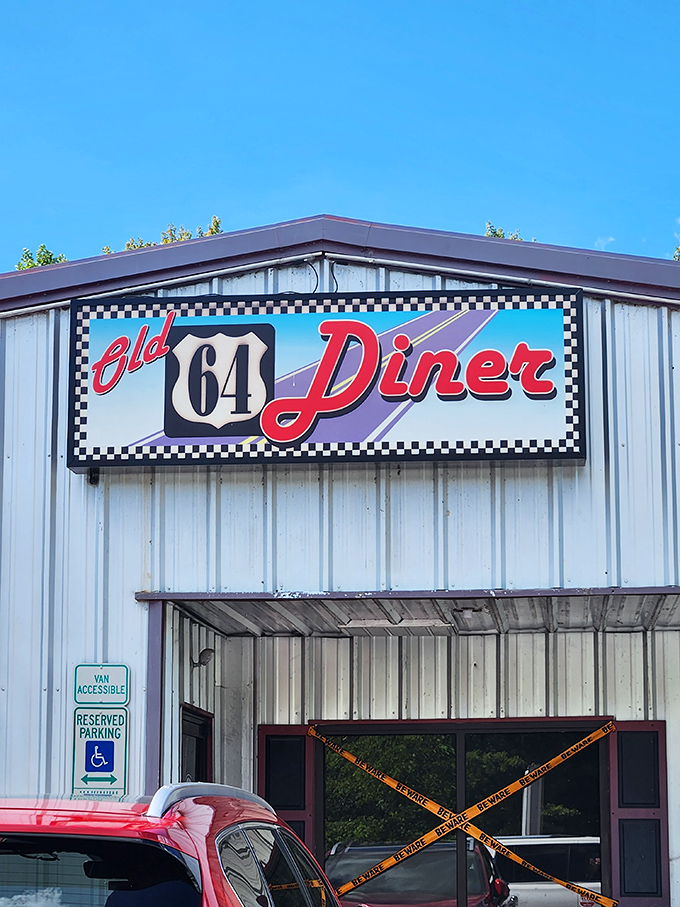 The classic checkered border sign beckons like a time portal to the 1950s. No DeLorean required for this journey back in time.