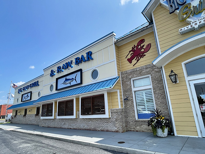 The cheerful yellow exterior with its signature blue roof stands like a maritime beacon, promising seafood treasures within Wilmington's revitalized Riverfront district.