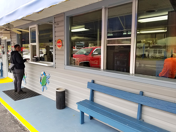 The iconic blue awning and simple sign of Calabash Seafood Hut stand as a beacon for seafood pilgrims. No fancy frills needed when the food speaks this loudly.