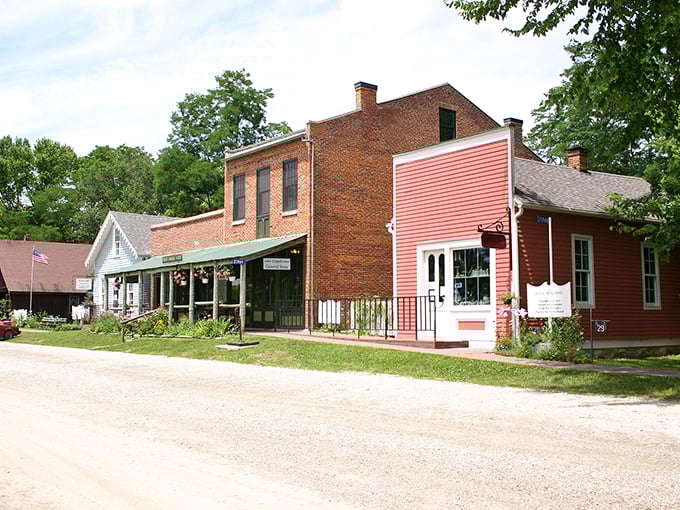 Historic storefronts framed by blooming peonies &ndash; Bentonsport's main street looks like a film set where modern life agreed to take a breather.