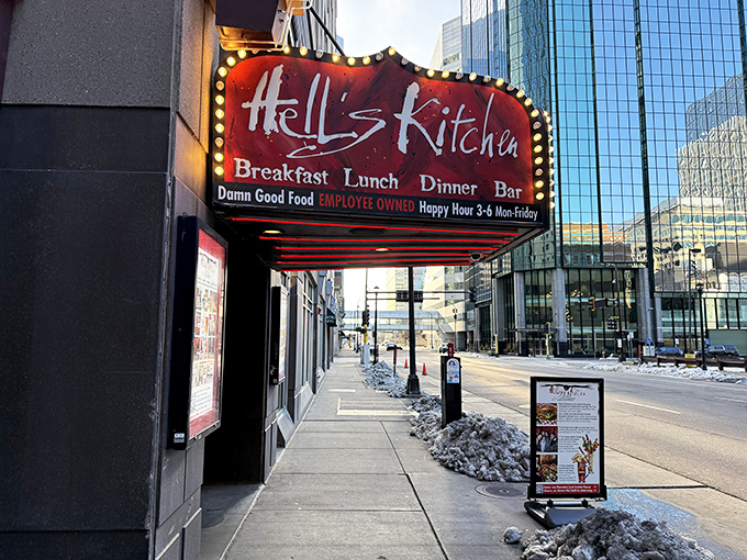 The entrance to culinary rebellion: Hell's Kitchen's bold red signage promises "Damn Good Food" &ndash; a Minneapolis institution that delivers on its devilish declaration.