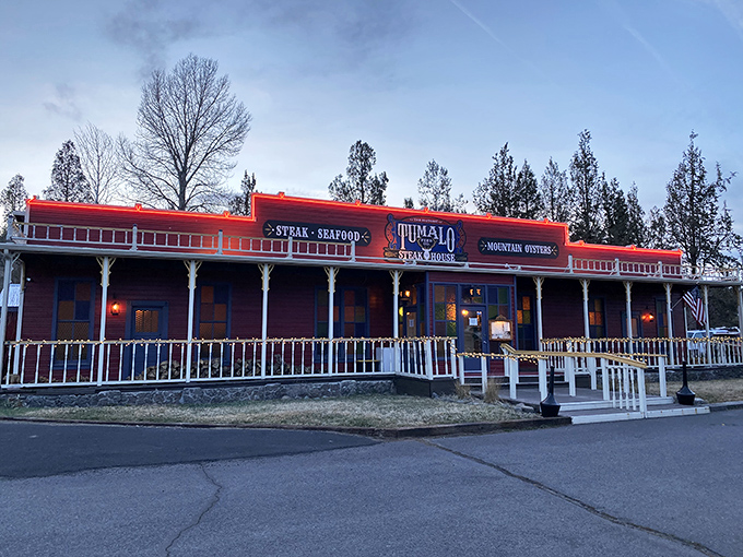 The iconic red exterior of Tumalo Feed Co. stands like a Western mirage against the Oregon sky, promising carnivorous delights within.
