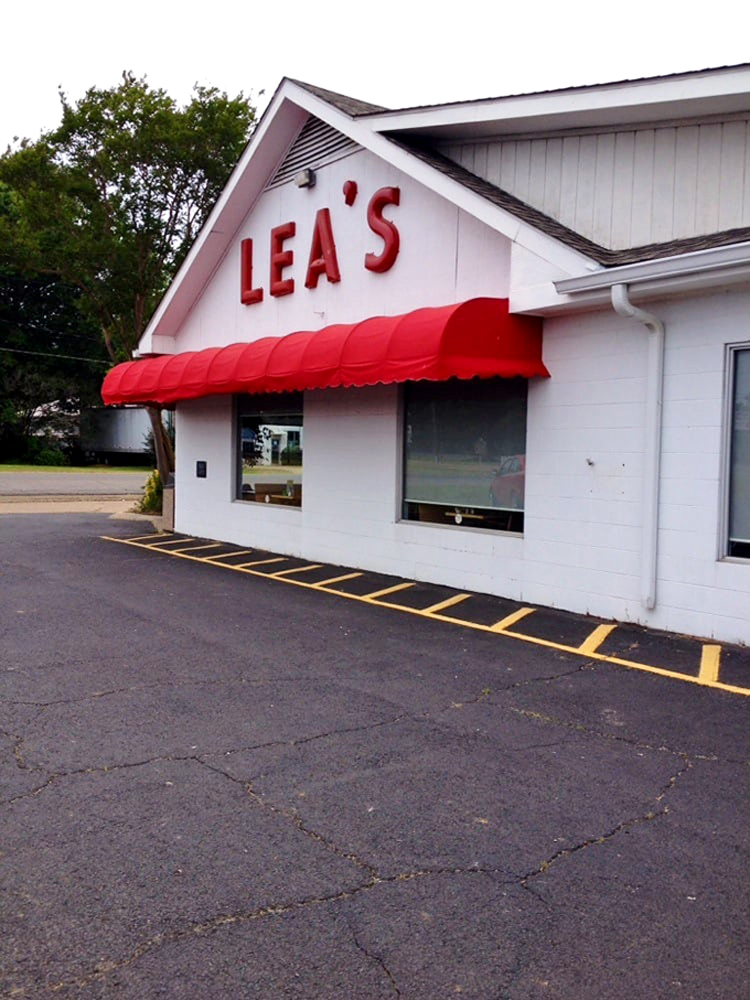 The iconic white building with bold red "LEA'S" lettering and matching awning stands as a beacon for hungry travelers &ndash; a Louisiana landmark since 1928.