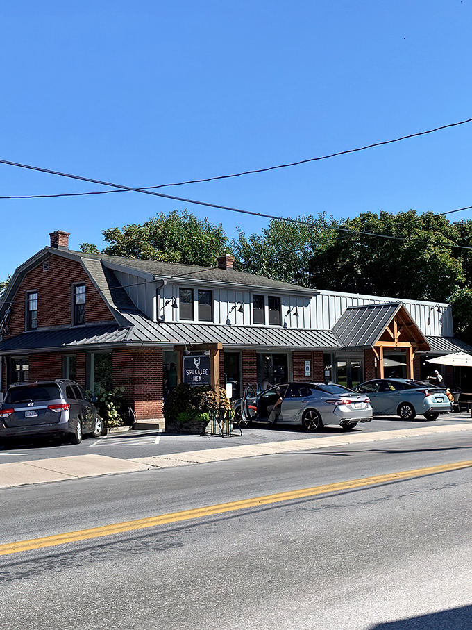 The red brick building with its rustic wooden sign promises culinary treasures within. Like finding a secret map to breakfast paradise in Amish country.