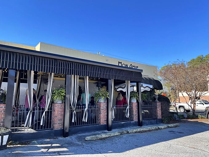 The sunshine-yellow exterior of Mon Amie isn't just a building&mdash;it's a morning promise waiting to be kept. French charm meets Southern hospitality behind those striped awnings.