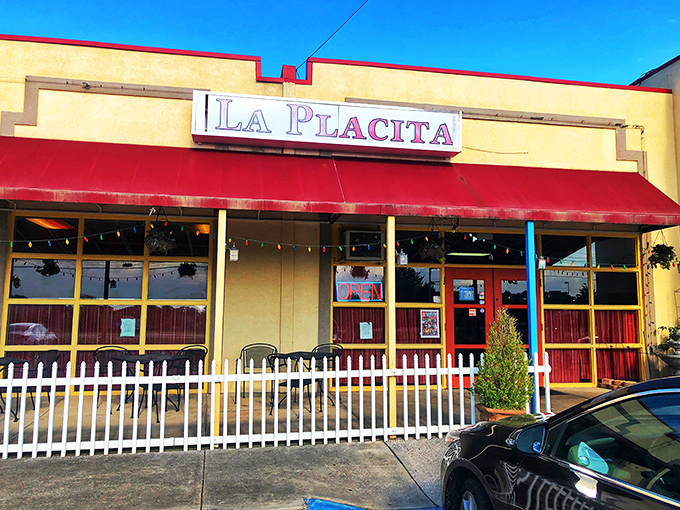 La Placita's cheerful exterior beckons with its bright yellow walls and red awning&mdash;like a sunset wrapped around a building that promises culinary adventure inside.