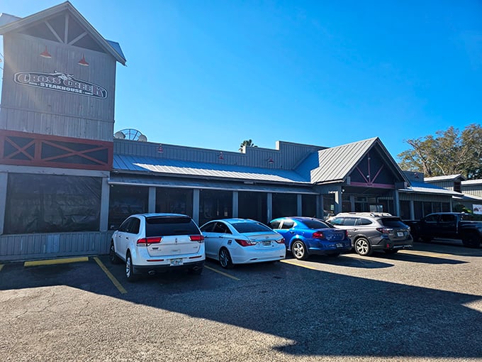 Cross Creek's neon-lit exterior transforms into a beacon of Southern comfort as dusk falls, promising culinary adventures within those wooden walls.