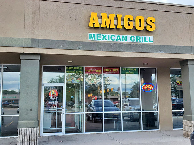 The bright yellow "AMIGOS" sign beckons like a lighthouse for hungry souls. No fancy frills, just the promise of authentic Mexican goodness waiting inside.