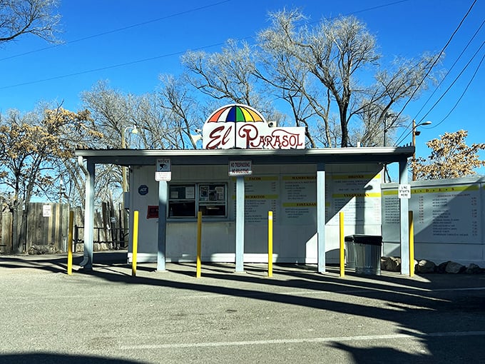 The humble roadside stand with its cheerful umbrella logo promises more flavor per square foot than establishments ten times its size.