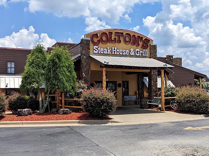 The rustic stone facade of Colton's stands like a carnivore's lighthouse, beckoning hungry travelers with promises of perfectly grilled protein.
