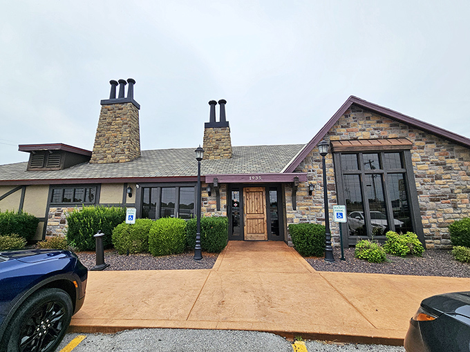 Rustic stone walls and lush landscaping welcome hungry visitors like an edible fairytale castle where the happy ending involves perfectly cooked beef.