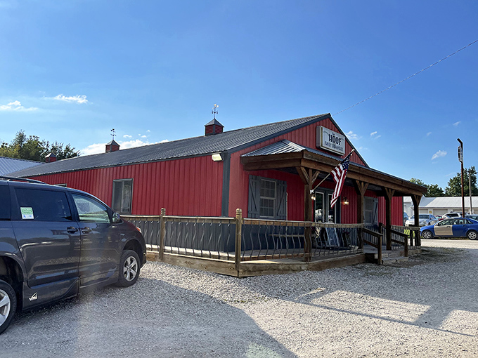 The iconic red exterior of The Hoof glows like a beacon at dusk, promising carnivorous delights within its barn-inspired walls.